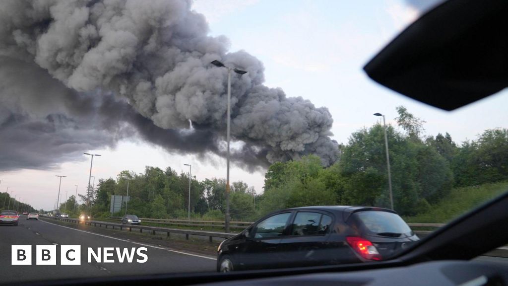 'Loud explosions' as firefighters tackle industrial blaze - BBC News