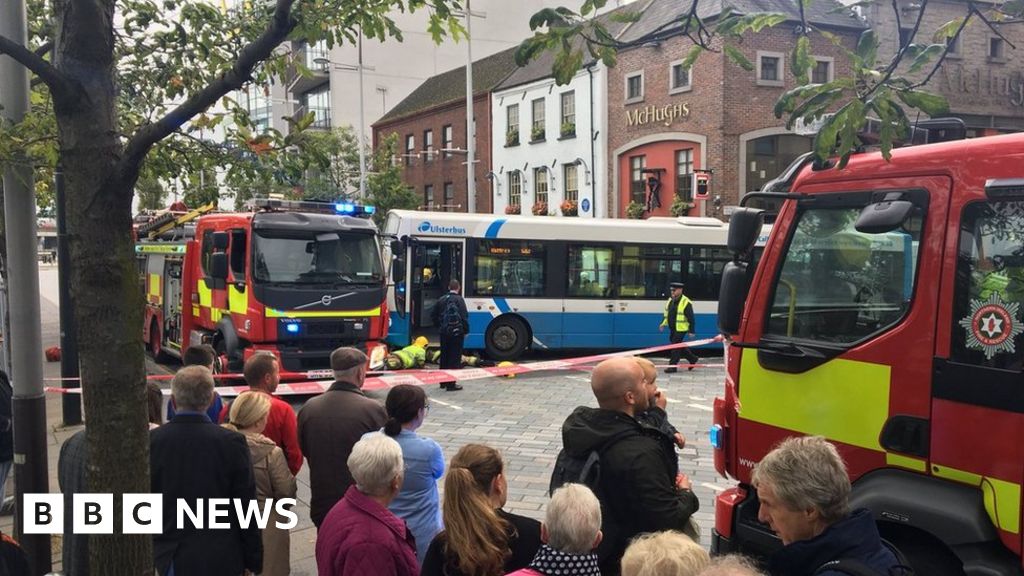 Belfast emergency services free person trapped under bus - BBC News