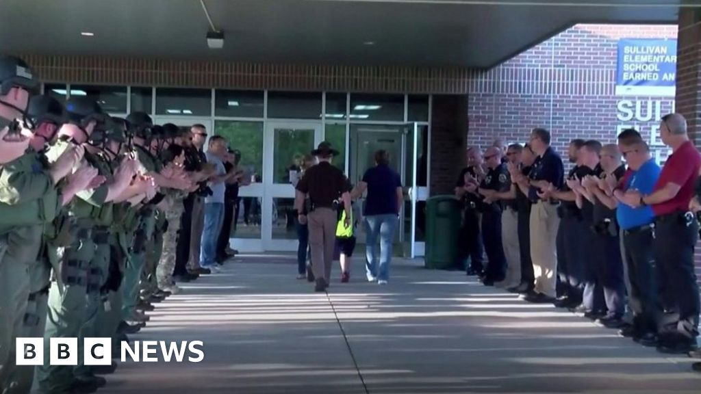 Police force escorts slain officer's son to school - BBC News