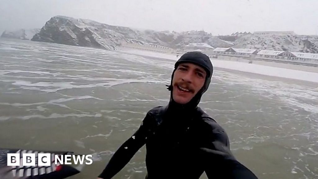 Cornwall surfer Simon Shields hits the waves as snow falls - BBC News