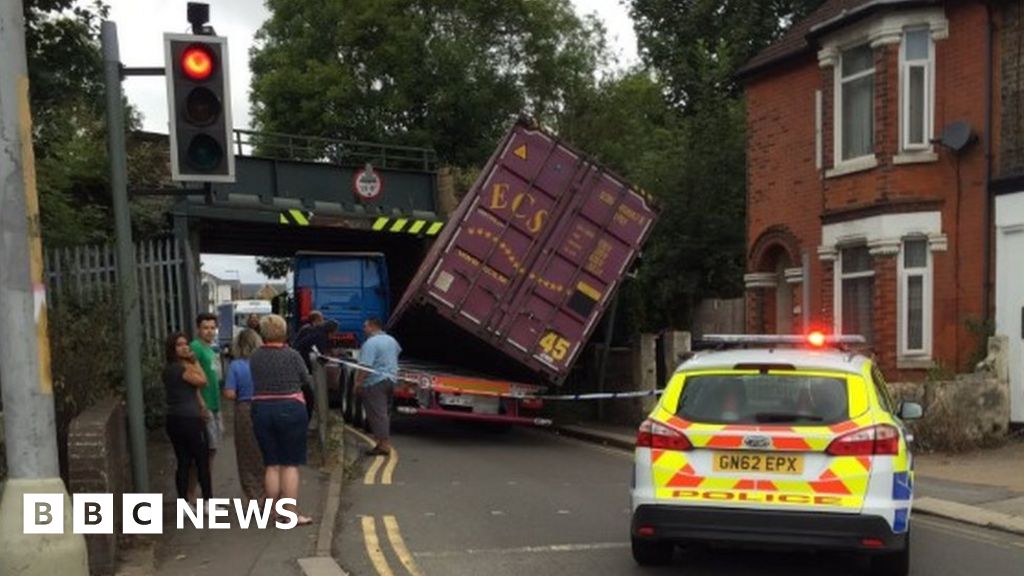 Lorry strikes railway bridge and sheds load - BBC News