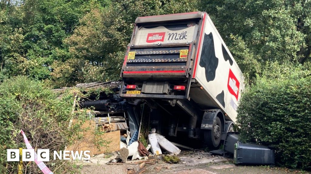 Woman hurt as Müller milk lorry crashes into garden in Brinsley