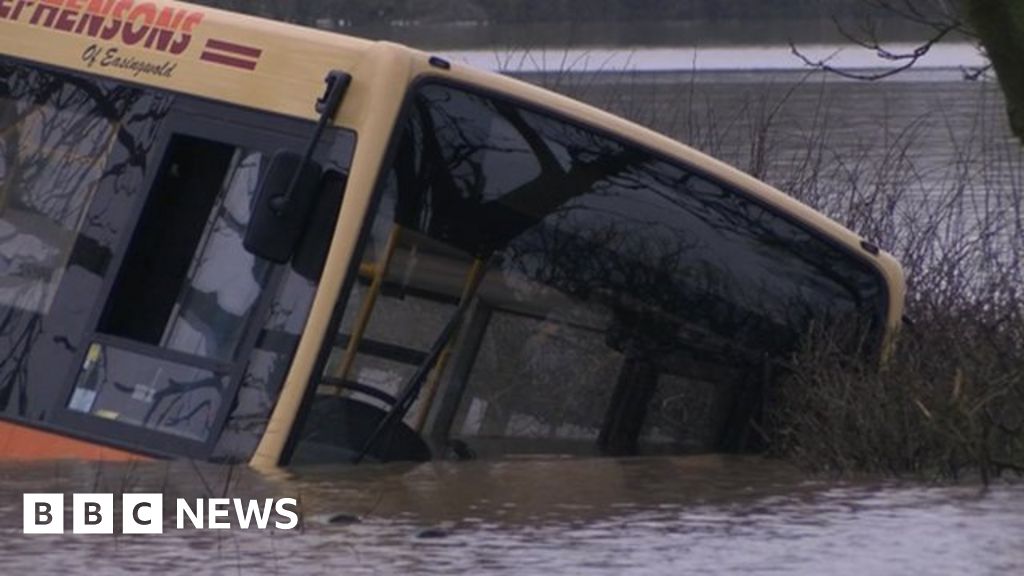 School children trapped in bus by flood water near York - BBC News