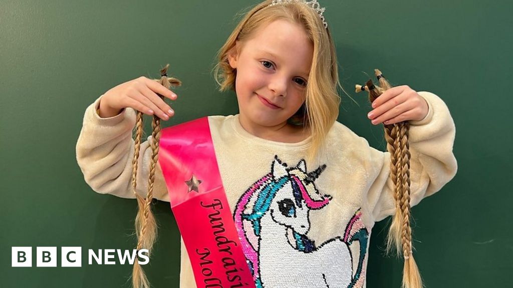 Molly, seven, has hair cut for charity - BBC News