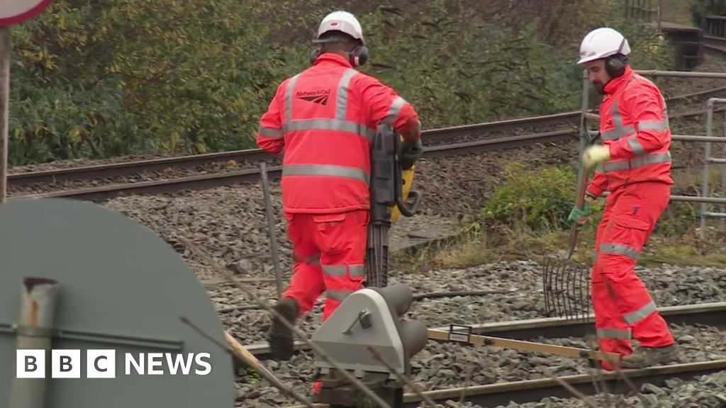 Devon rail line cut off by floods reopens - BBC News