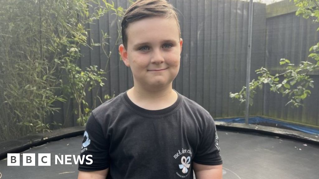 Boy with amputated limbs gets accessible garden makeover - BBC News