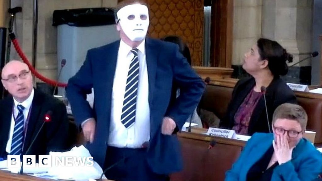 Local elections: Masked councillor issues photo ID warning - BBC News