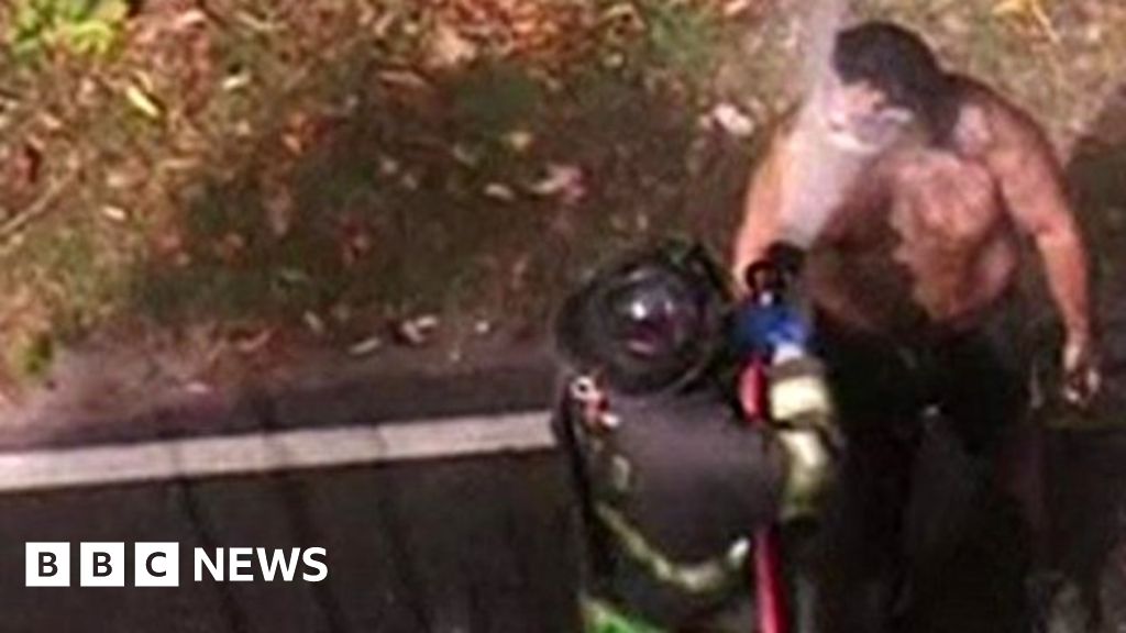 Man hosed down after rescue from storm drain - BBC News