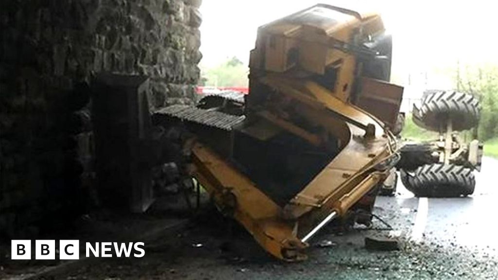 Train services hit as digger crash damages railway bridge - BBC News