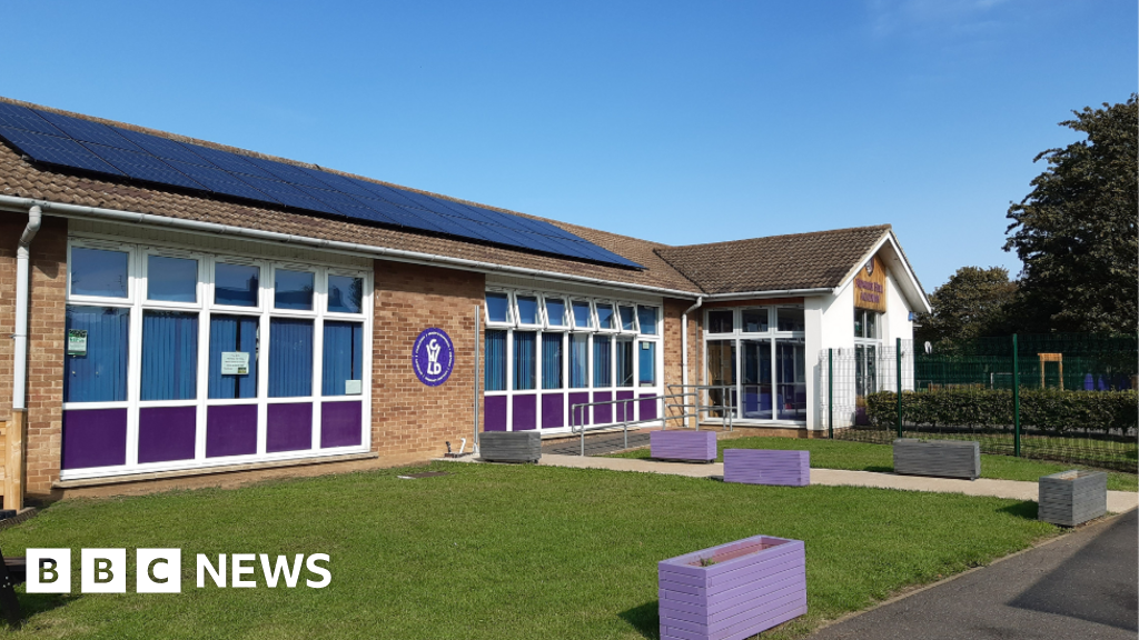Peterborough school to keep lollipop patrol amid budget cuts - BBC News