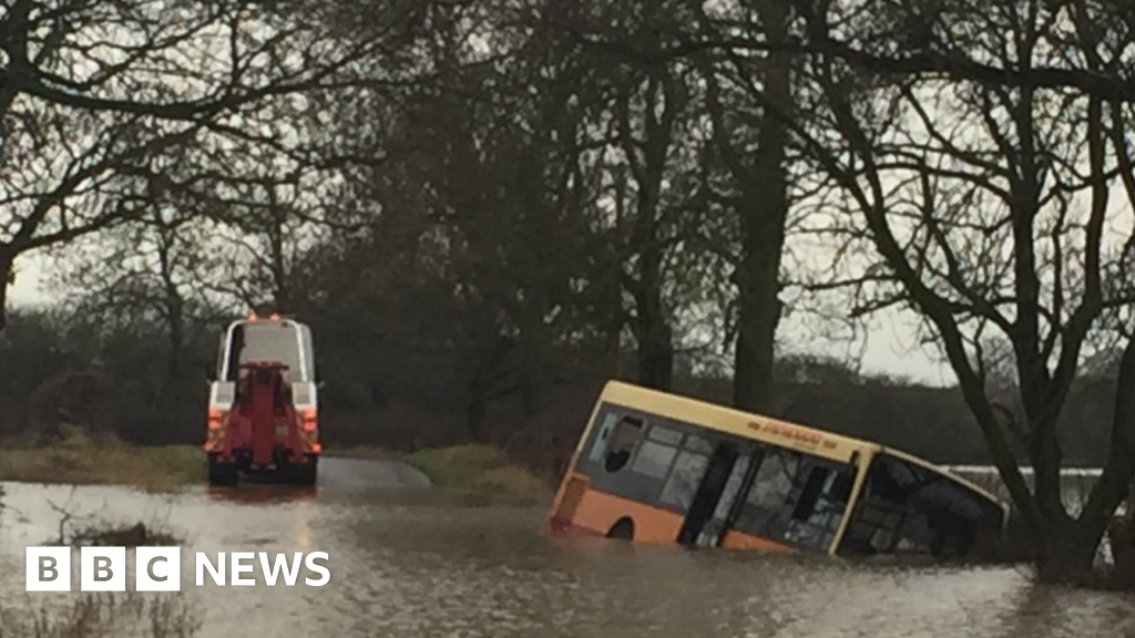 School children trapped in bus by flood water near York - BBC News