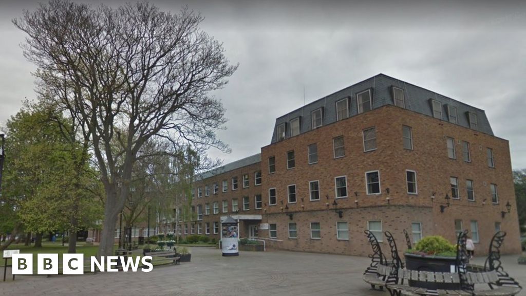 Wrexham council backs budget despite protests over cuts - BBC News