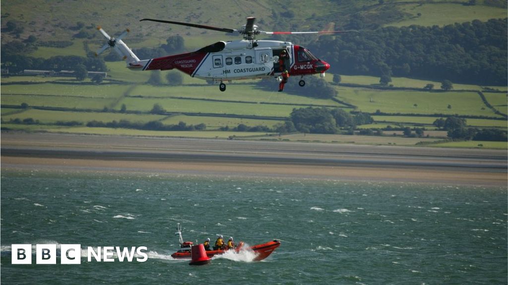 Two rescued from capsized catamaran off Llanfairfechan - BBC News
