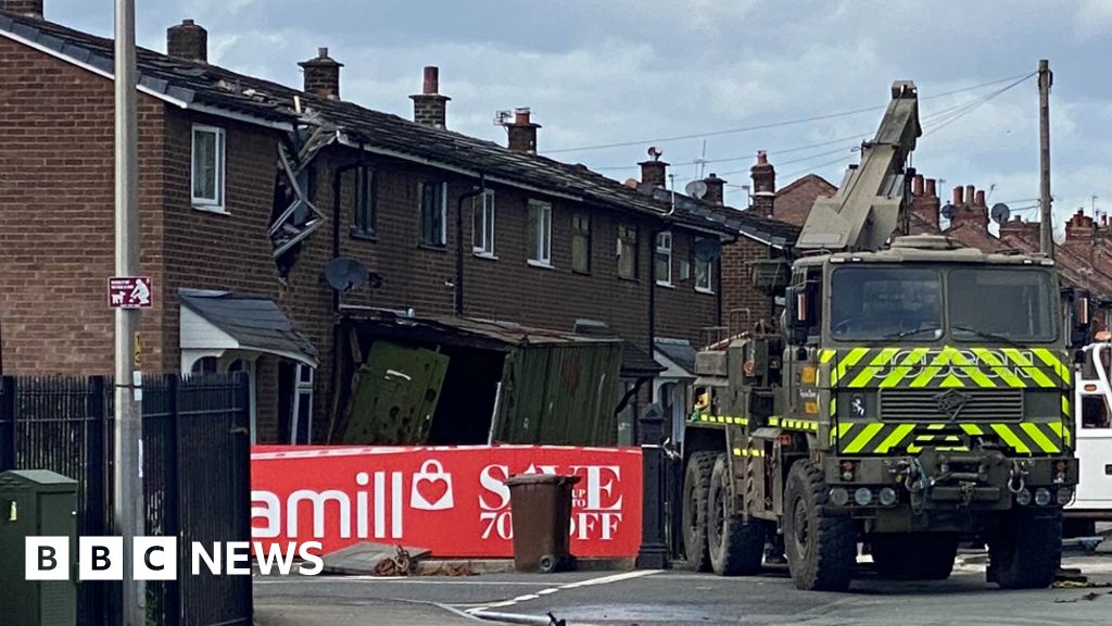 Crane smashes into Wigan house after lorry overturns - BBC News