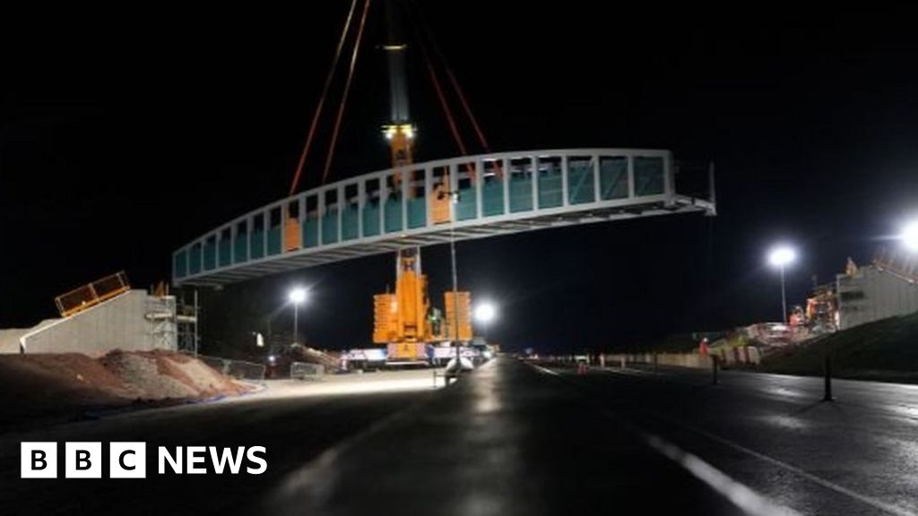 Cycle bridge installed over A30 at Chiverton - BBC News