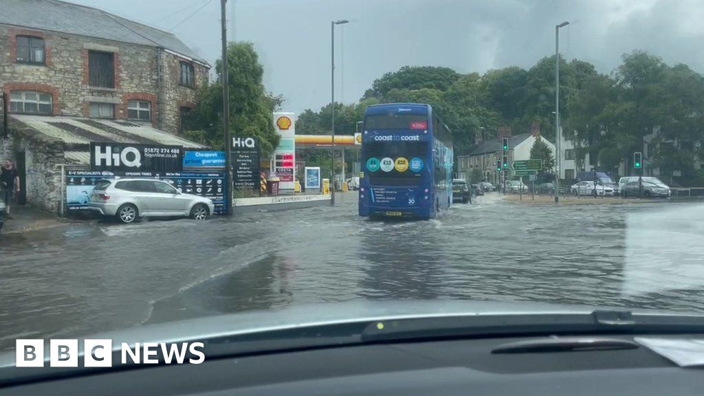 Flash flood hits Truro roundabout amid weather warning - BBC News