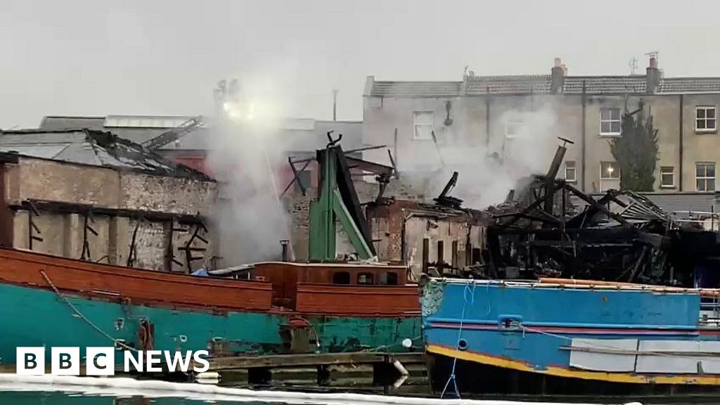 Fire crews dampen down after blaze breaks out at boat yard