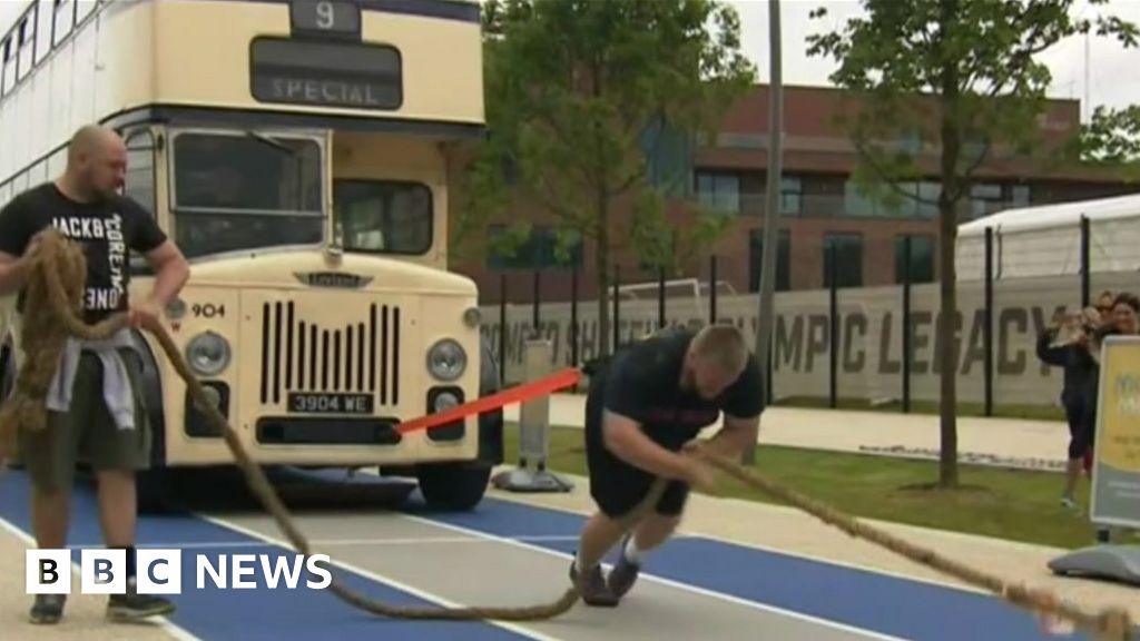 World Champion strongman Paul Smith pulls double decker bus