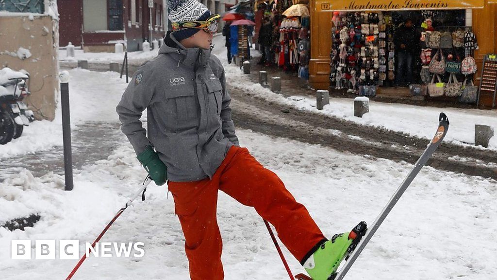 Skiers and snowboards in the Paris snow - BBC News