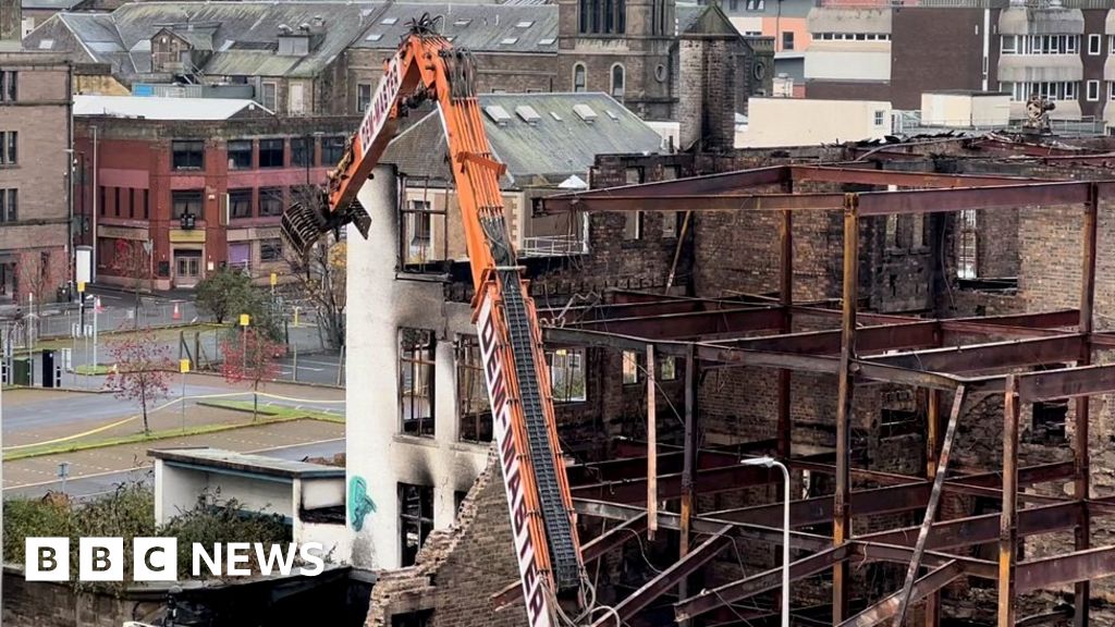 Demolition work under way on fire-ravaged building