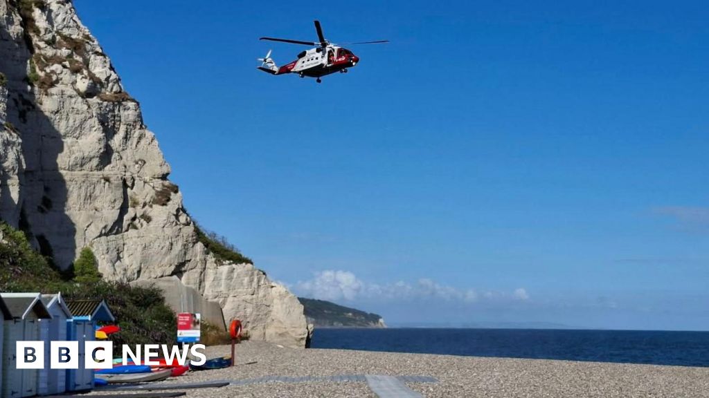 Helicopter rescues two people stuck on rocks in Devon