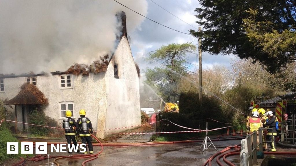 Alton Pancras thatch fire shuts road and cuts power to village - BBC News