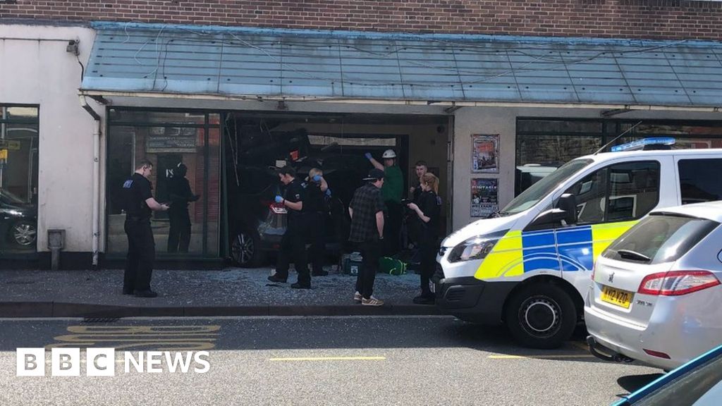 Two hurt as car crashes through Wrexham building