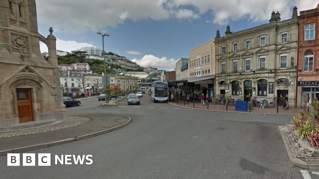 Man 'stable' after falling 50ft from Torquay building - BBC News