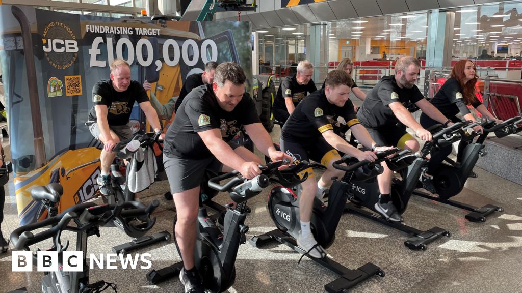 Staffordshire JCB cyclists finish 'around the world' challenge - BBC News