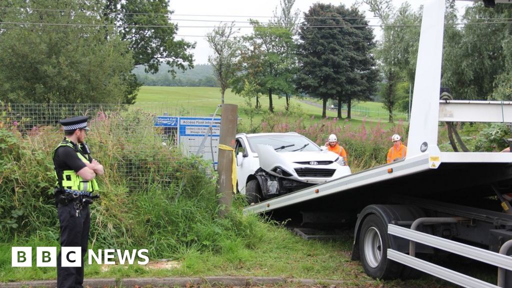 Motorist hurt after train hits car on railway in Johnstone - BBC News