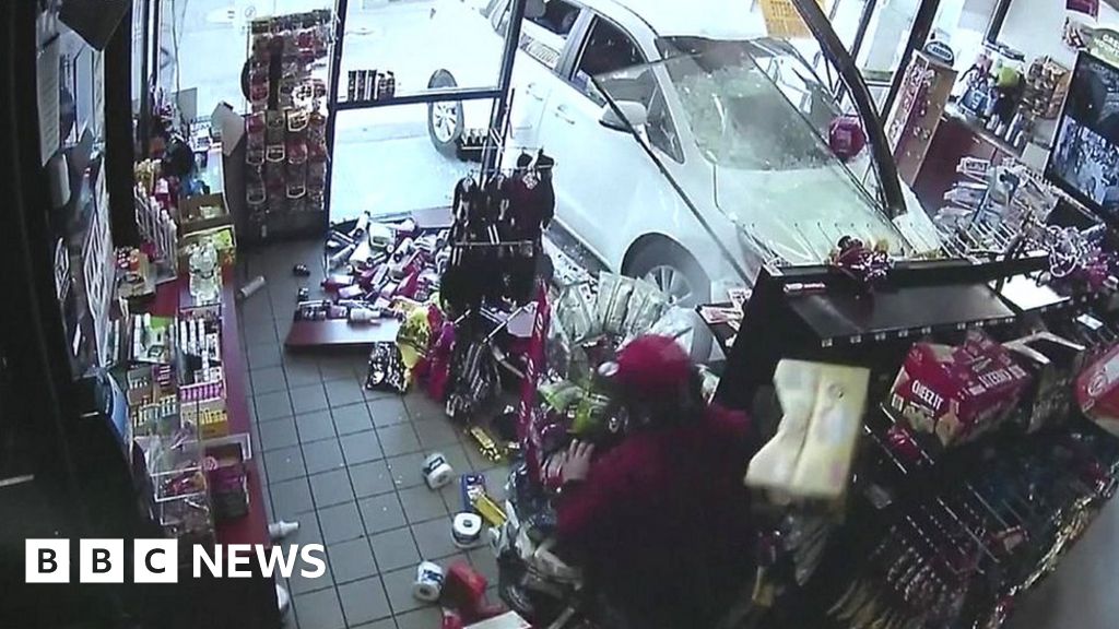 Shopper's lucky escape as car crashes through window - BBC News