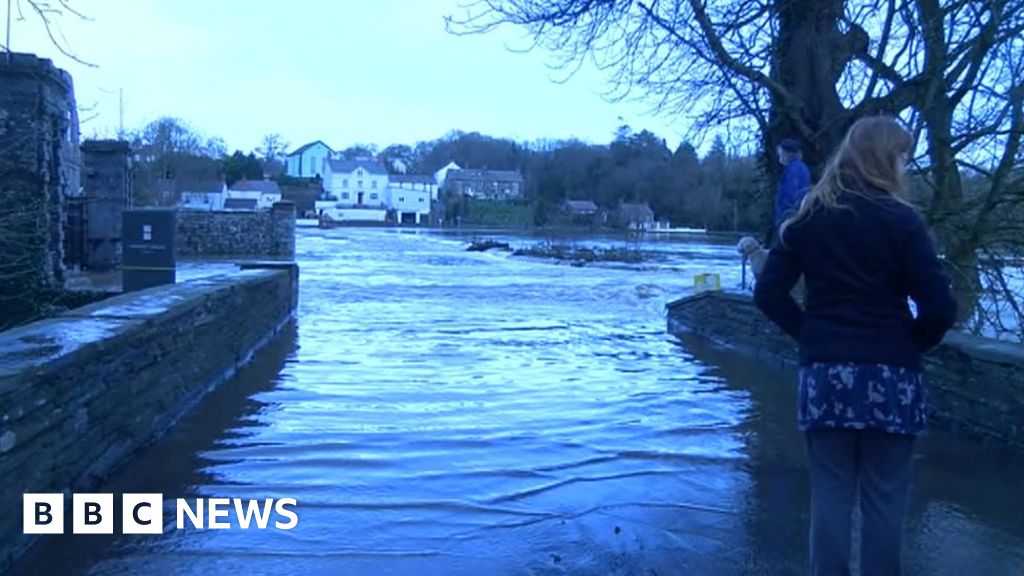 Bridge submerged as flooding affects parts of Wales - BBC News