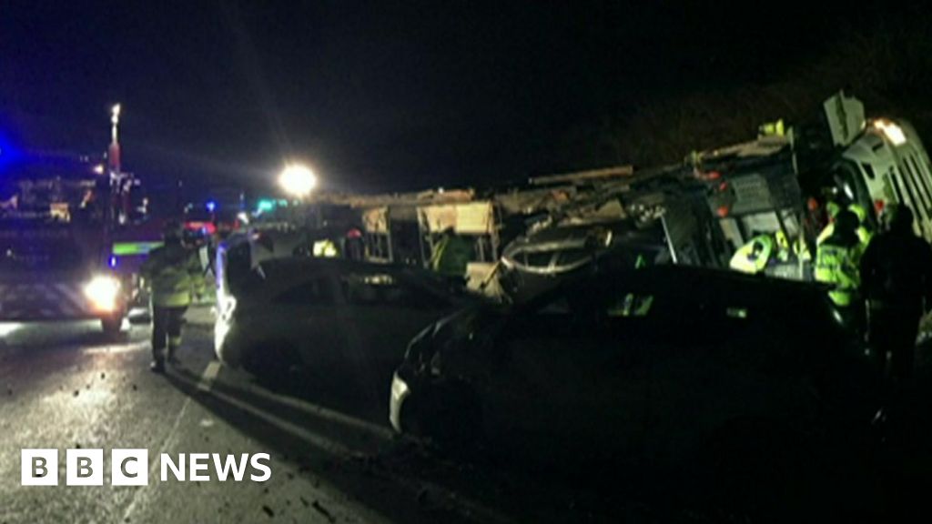 Twelve cars destroyed when transporter overturns in Devon - BBC News