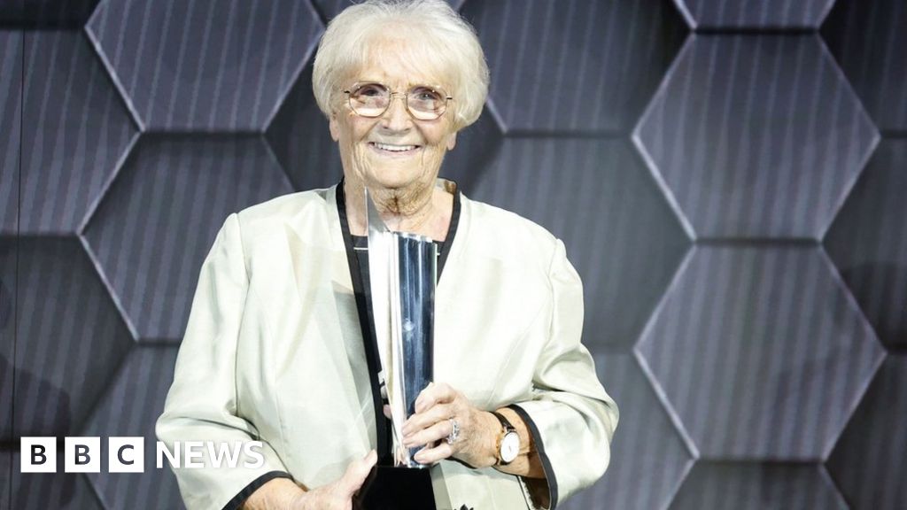 Manchester United's 'always smiling' receptionist honoured