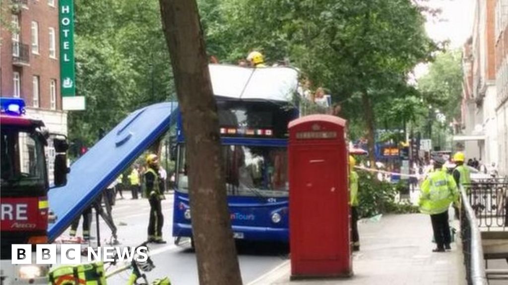 London tour bus driver 'let go of wheel' before crash
