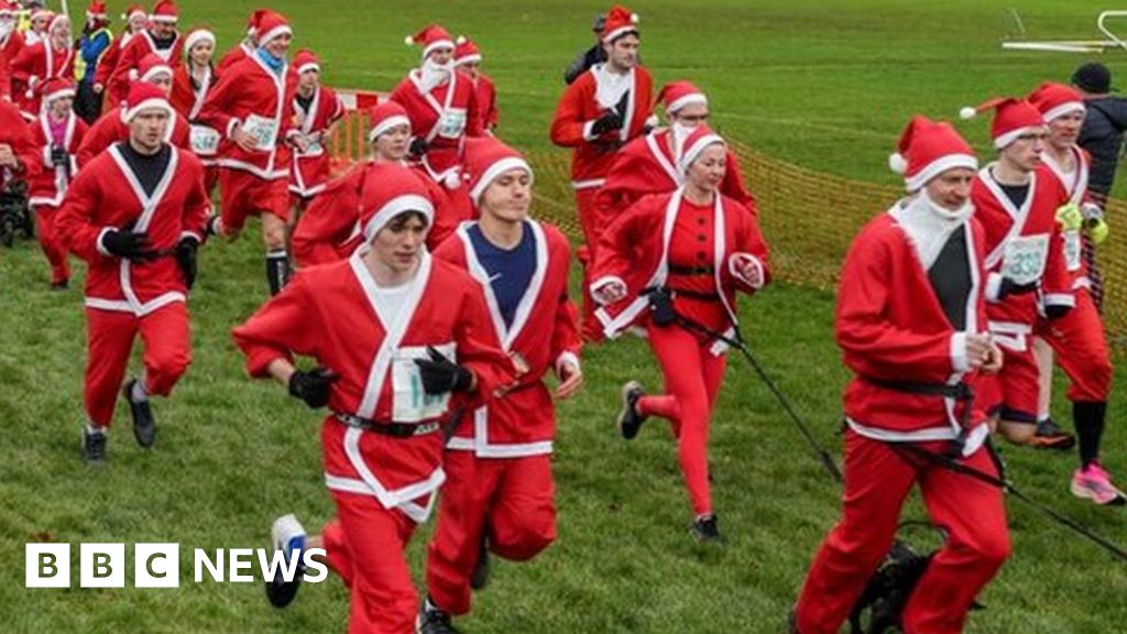 Hundreds of runners enjoy charity Santa Dash - BBC News