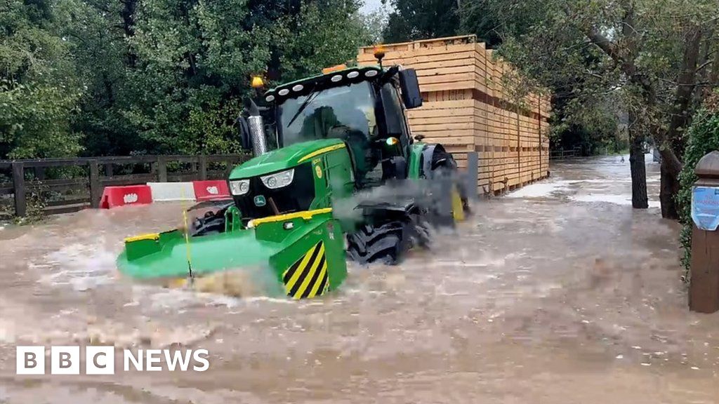 Watch: Tractor forces way through flooded Rufford ford - BBC News