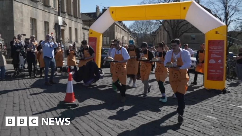Bath's first-ever waiter race raises money for charity - BBC News