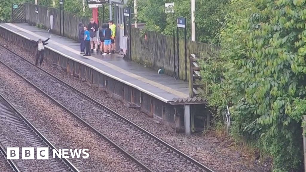 CCTV footage show moment boy jumps on railway tracks - BBC News