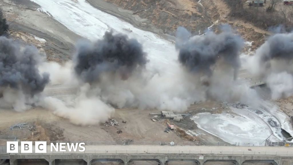 Watch: Moment bridge explodes in controlled demolition - BBC News