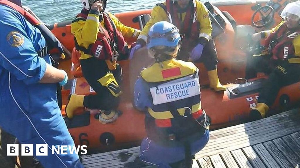 Exhausted Sandbanks swimmer rescued by passing boat - BBC News