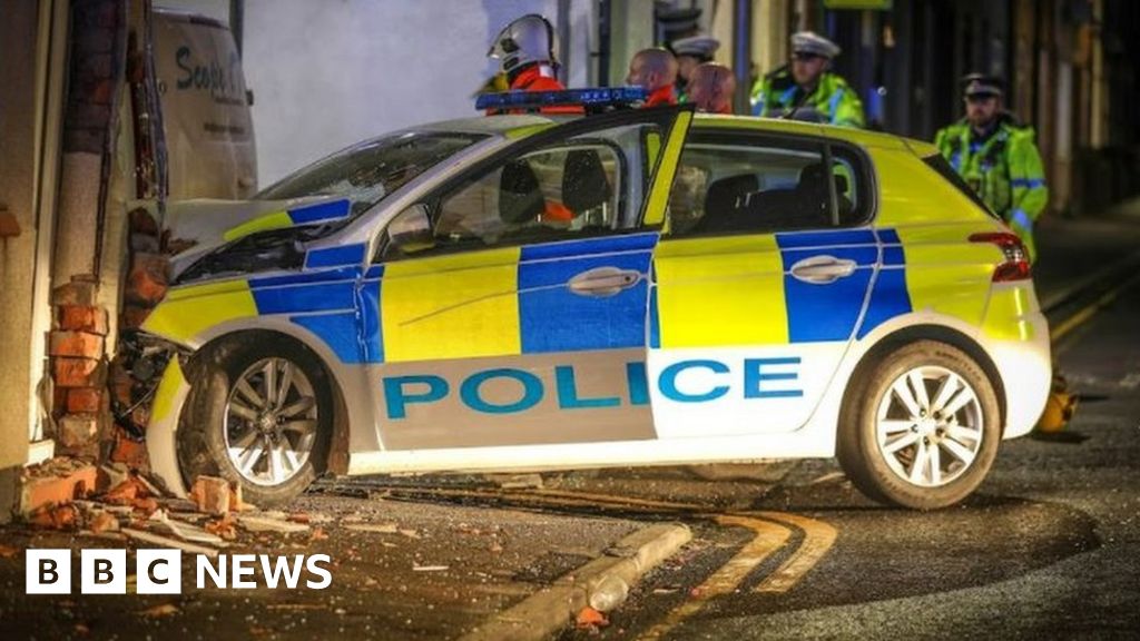 Four officers injured as police car smashes into house in Leigh - BBC News