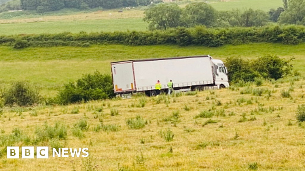 Lorry ends up in field in Wiltshire as driver falls asleep - BBC News