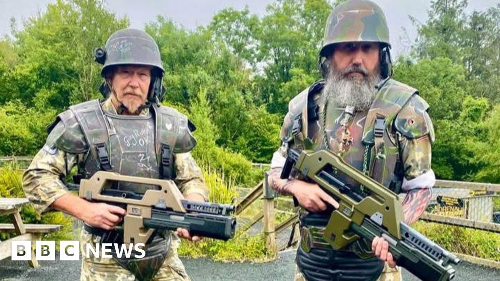 Duo take on zip wire dressed in space armour from Aliens film