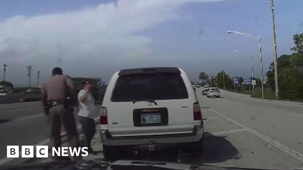 Police dashcam shows close call during highway crash - BBC News