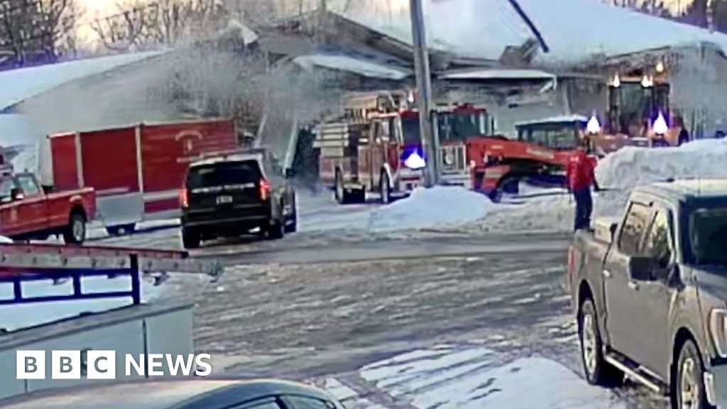Watch: Moment firehouse roof caves in under heavy snow - BBC News