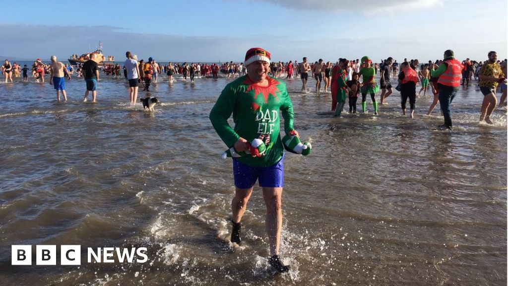 Hundreds take part in Tenby Boxing Day swim - BBC News