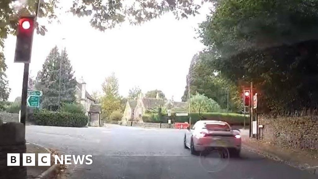 Footage shows man racing through red light at busy junction - BBC News