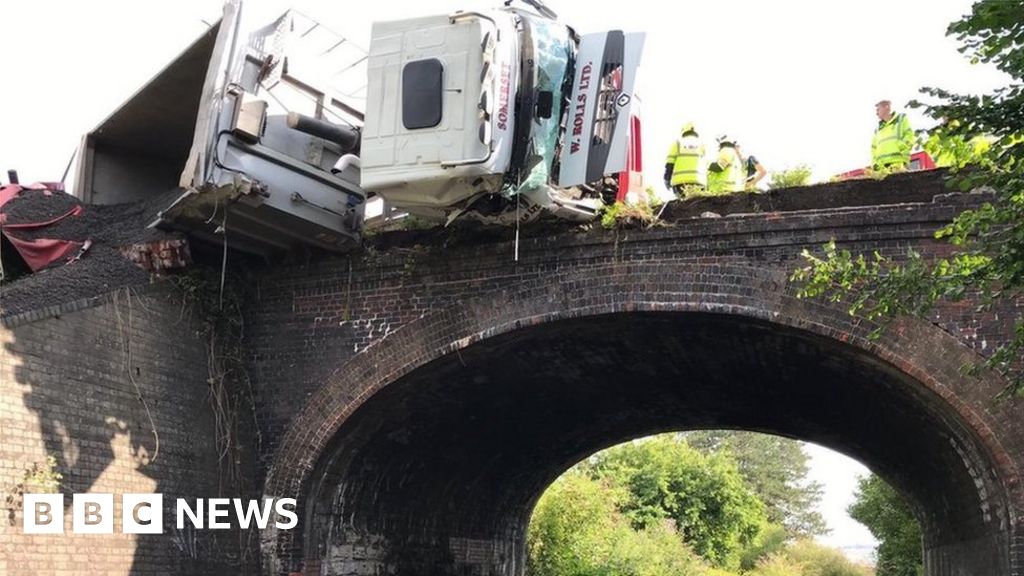 Lorry hits railway bridge and destroys wall
