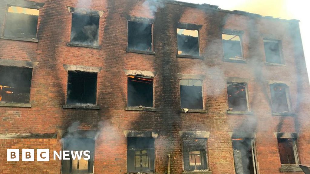 Fire crews work through night to extinguish derelict mill fire - BBC News